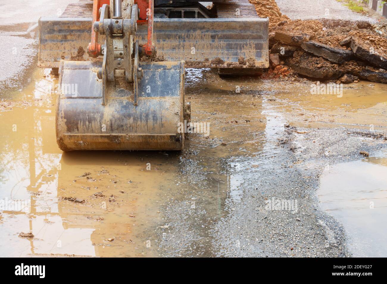 backhoe dig repair broken water line pipe main plumbing on road Stock ...