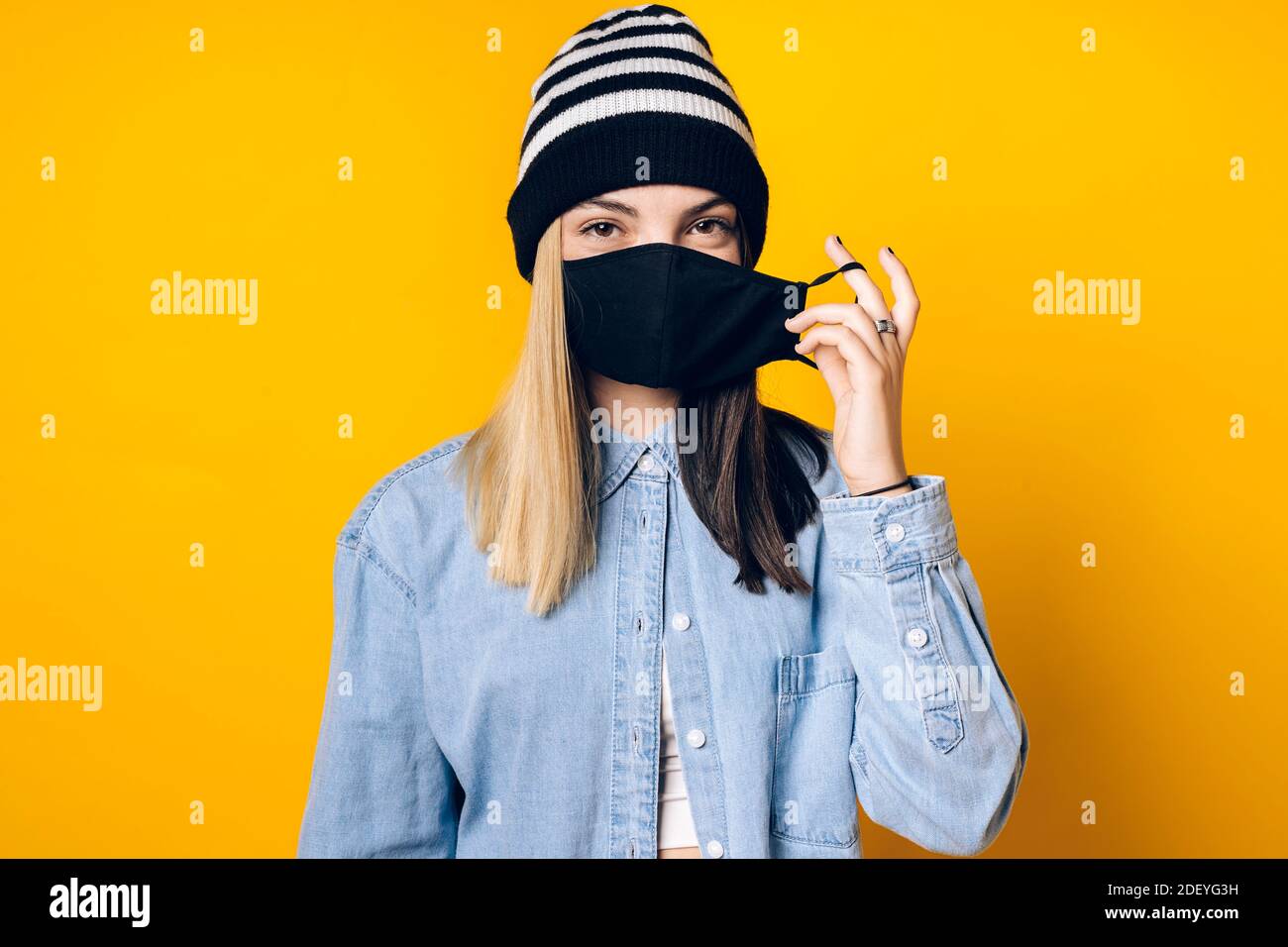 Stock photo of young pretty girl looking at camera in studio. She is ...