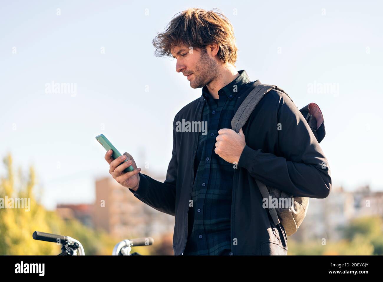 Stock photo of handsome man using his cellphone in the street Stock ...