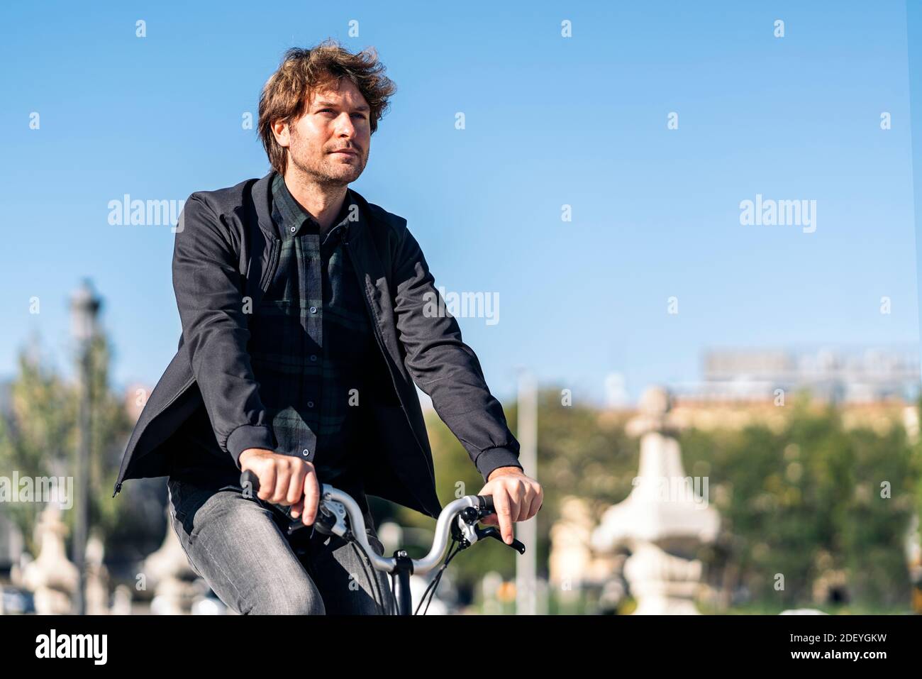Stock photo of handsome man using his detachable bike in the street ...