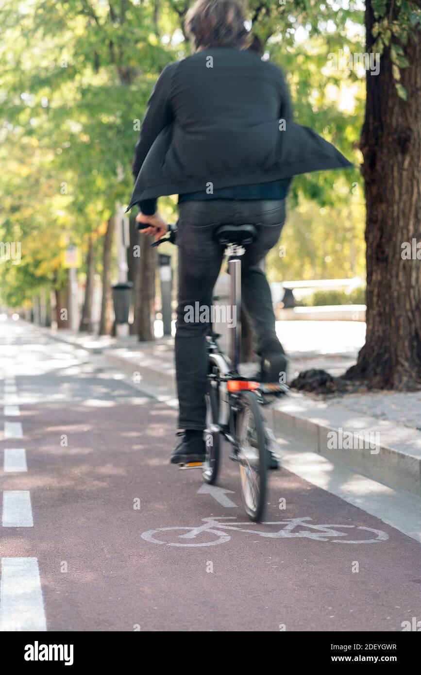 Stock photo of unrecognized man riding his bike following bike trail ...