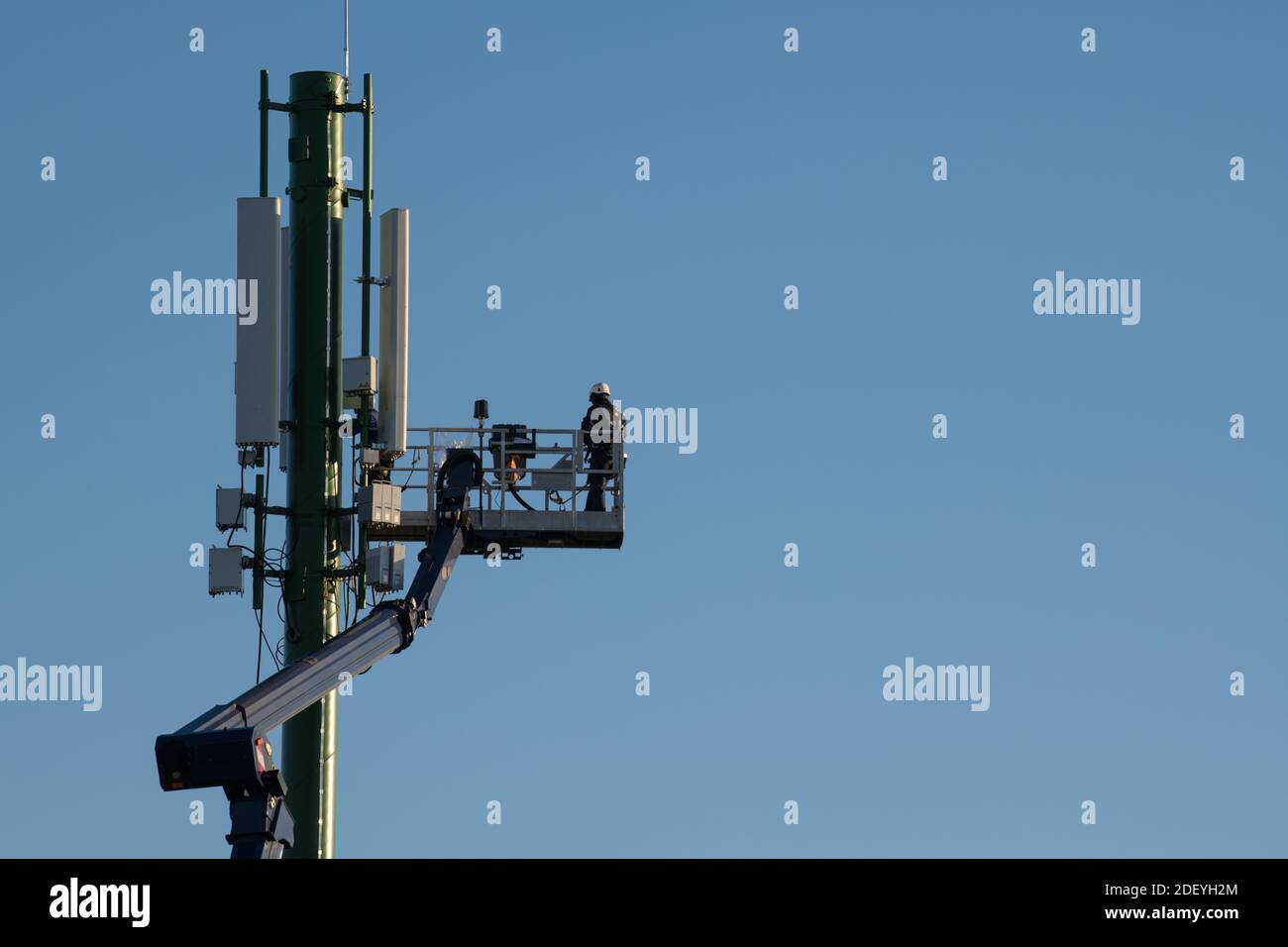 Telecommunications tower with 4G, 5G transmitters, Worker on cellular base station Stock Photo ...