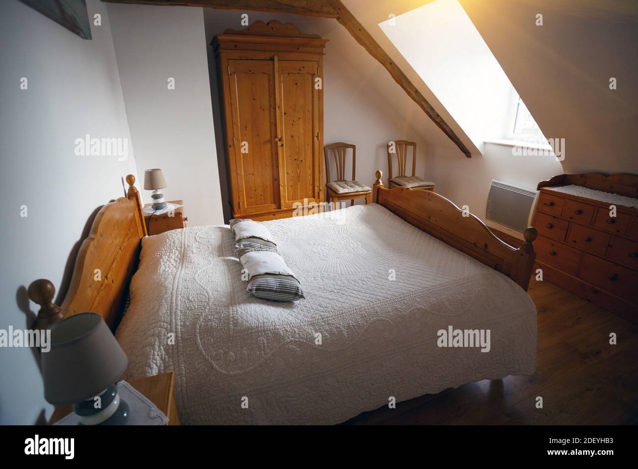 Bedroom and empty large bed in traditional rural style Stock Photo - Alamy