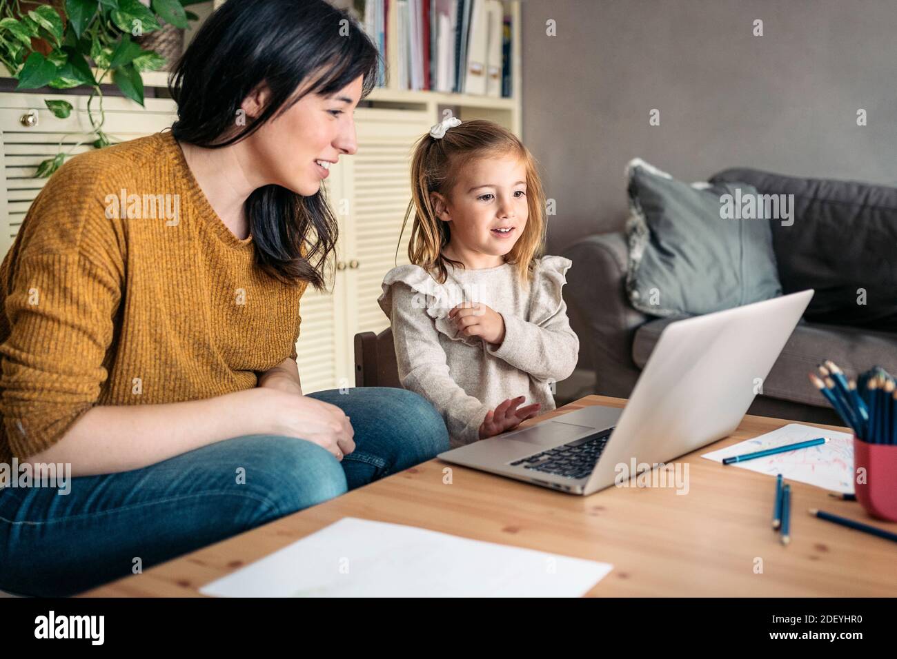 Stock photo of cute girl having fun in the living room using computer ...