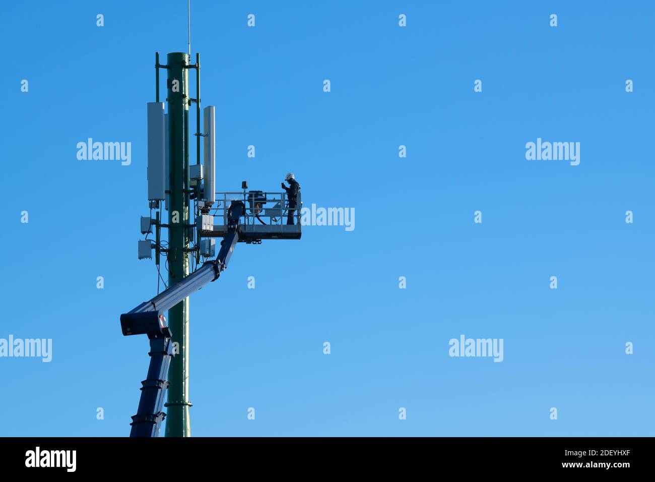 Telecommunications tower with 4G, 5G transmitters, Worker on cellular base station Stock Photo ...