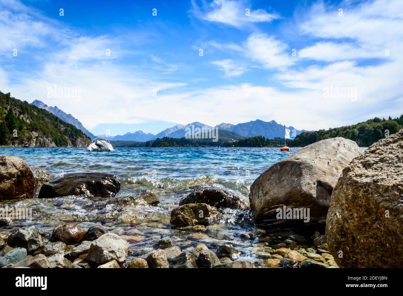 Beautiful lake of bariloche with rocks, pine trees, water, mountains ...