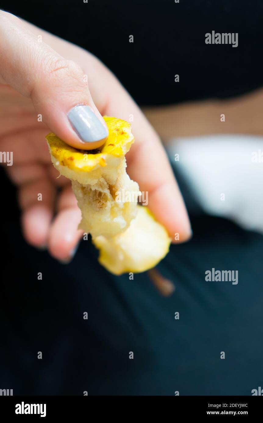 A vertical shot of a female hand holding rest of an eaten apple Stock ...