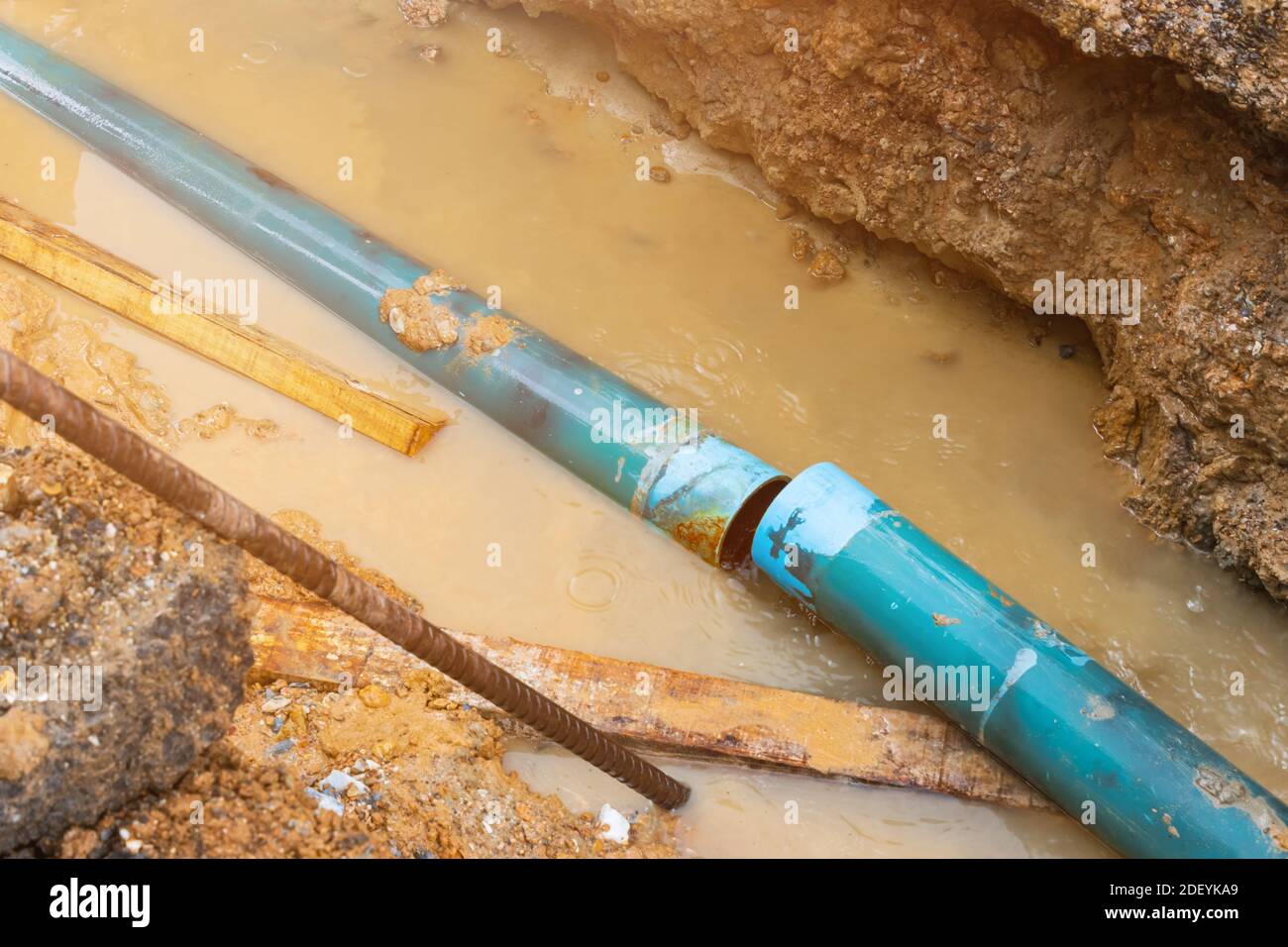repair the plumbing broken pipe and water flow in hole Stock Photo - Alamy