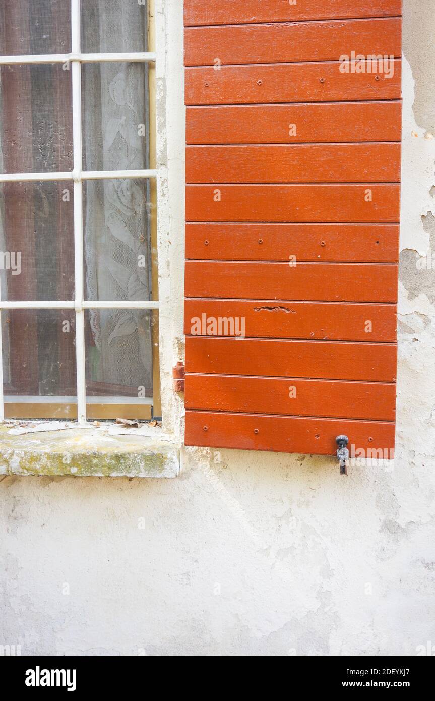 A vertical shot of a window with open cover of an old building Stock ...