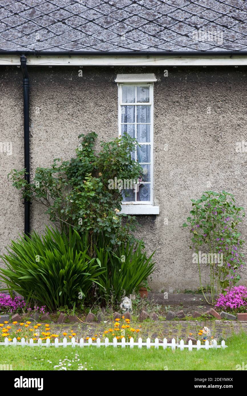 tiny window in old cottage with garden Stock Photo - Alamy