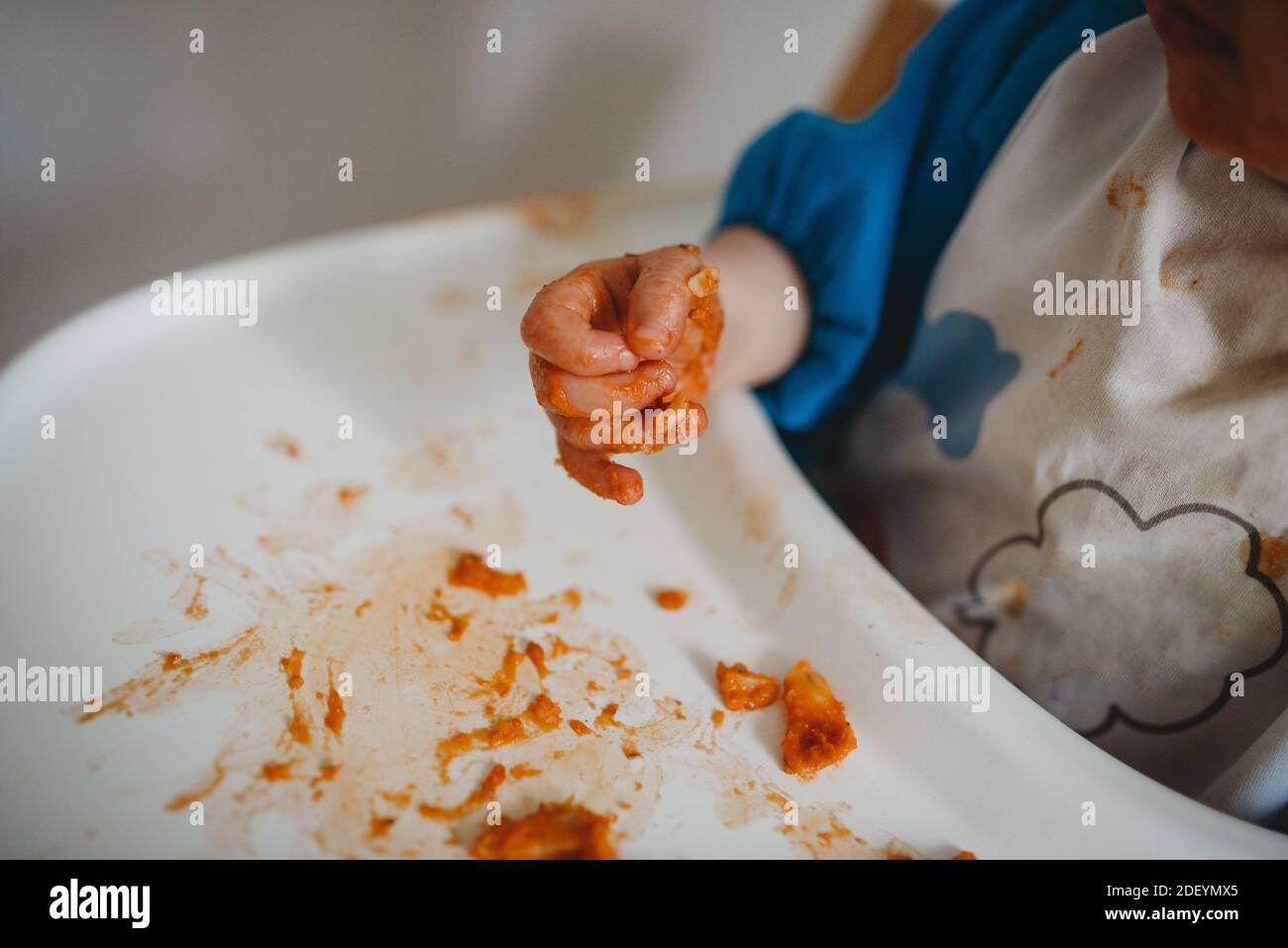 Close up of a baby's hands while eating and making a mess Stock Photo ...