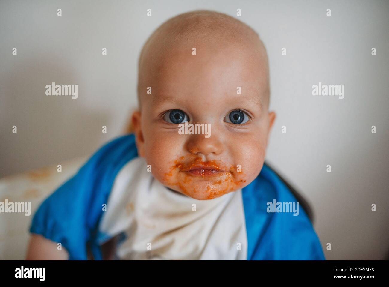 Portrait of a baby boy with food all over his face Stock Photo - Alamy