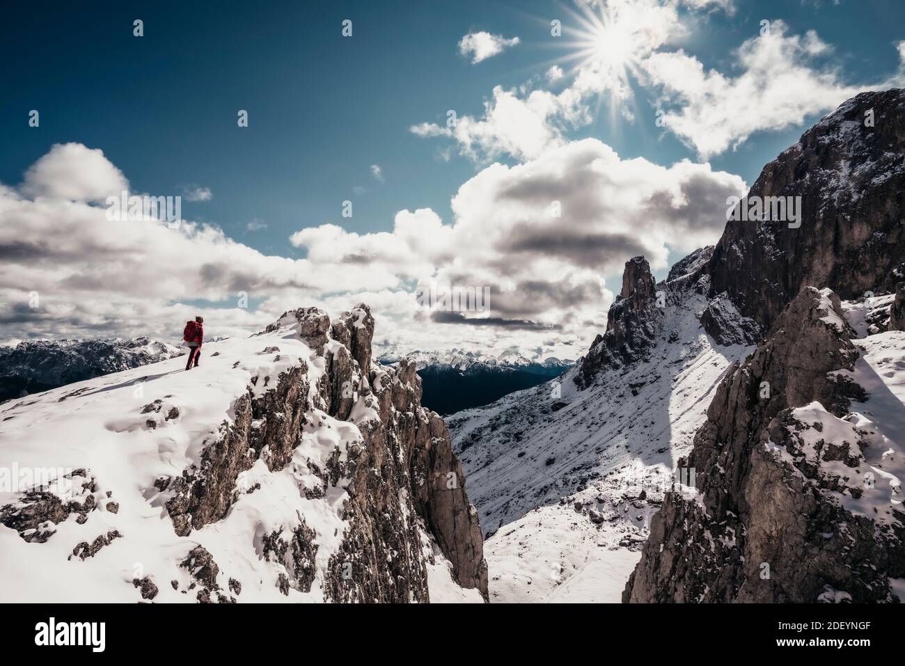 Female Alpinist overlooking scenic valley in the Italian Dolomites ...