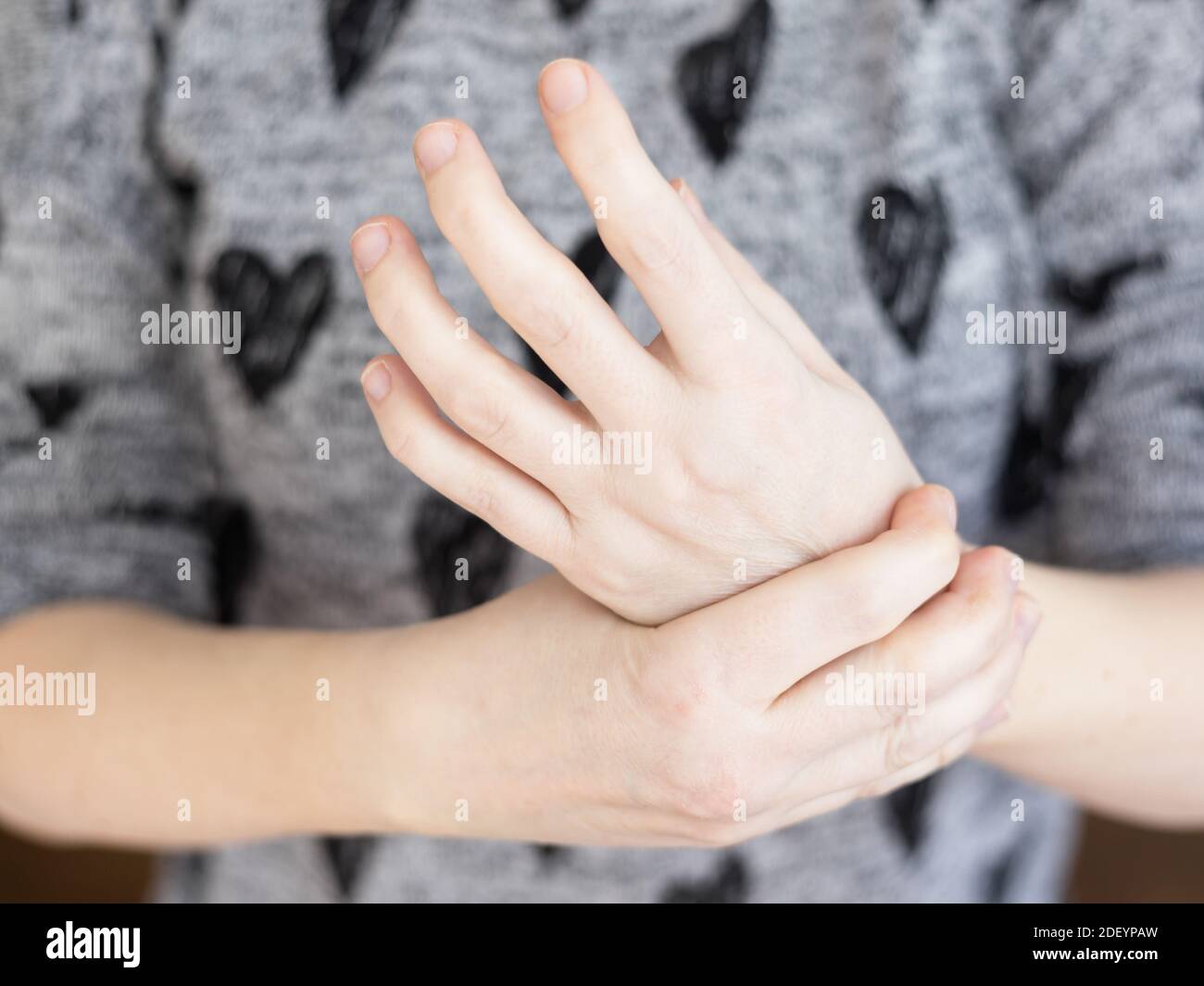 Close up young white woman suffering from pain in left wrist. Health c ...