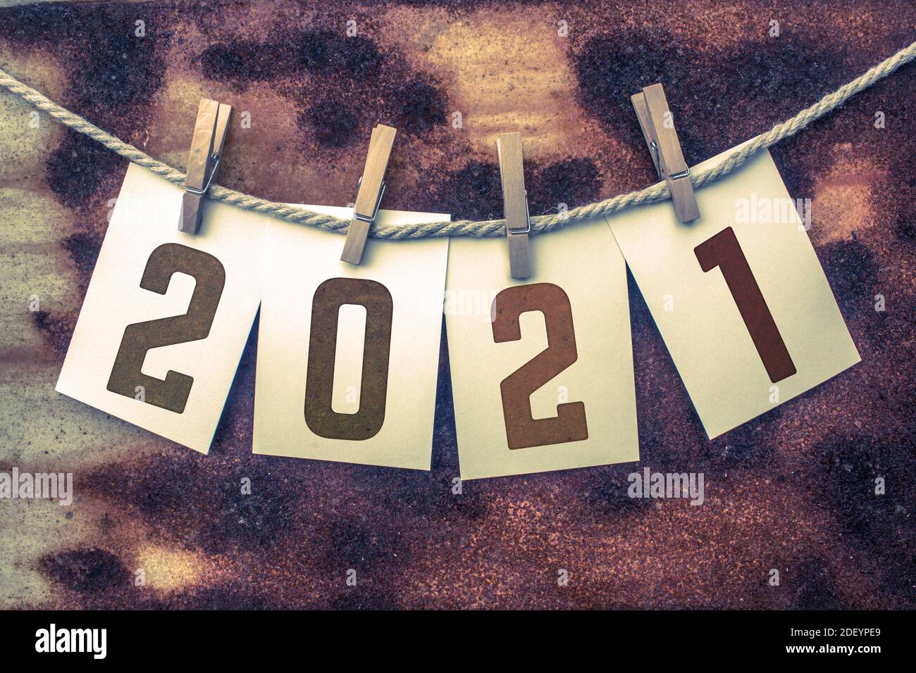 The year 2021 written on pinned cards against an old rusty background ...