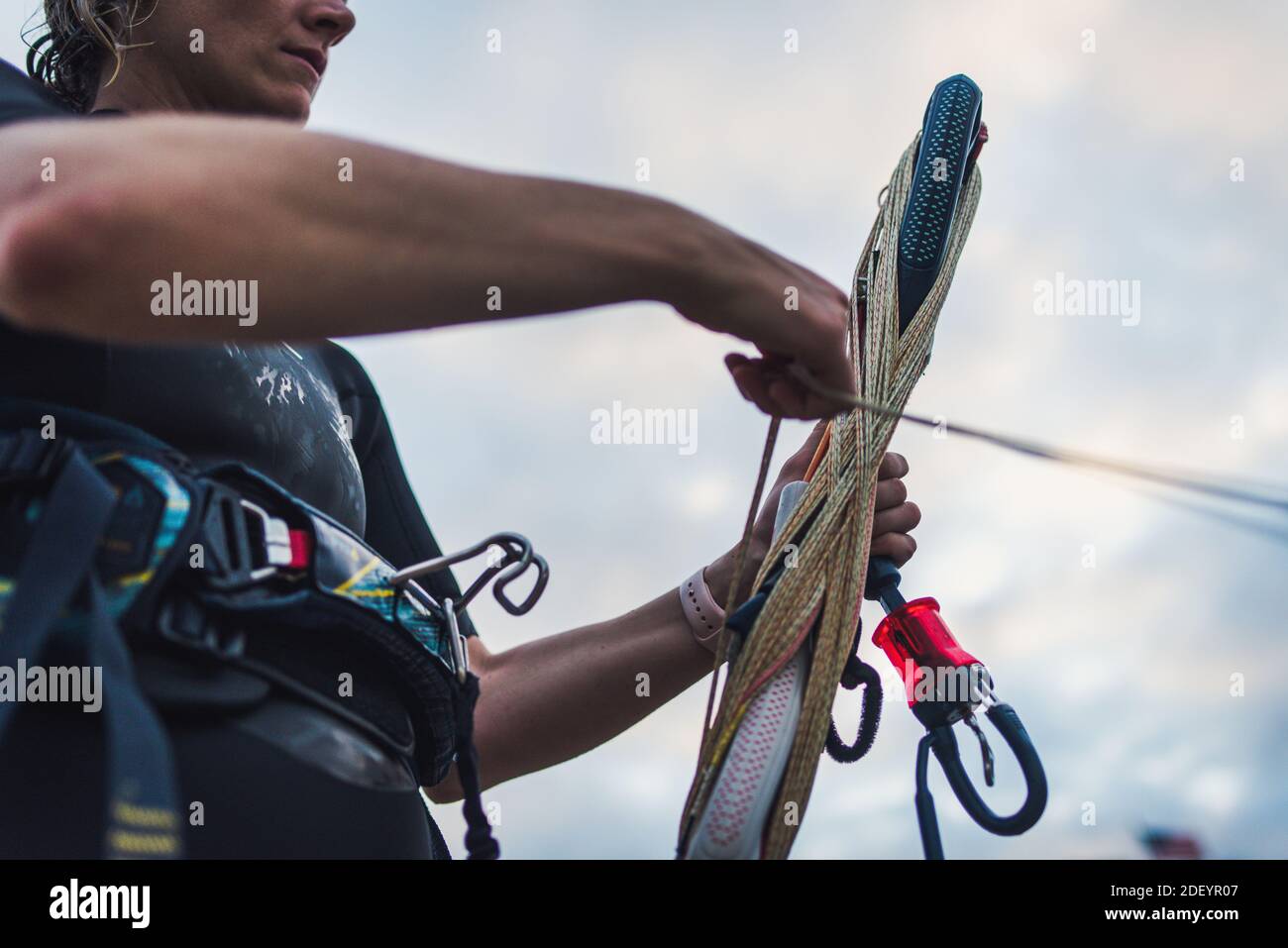 A woman wrapping up her kiteboarding line Stock Photo - Alamy