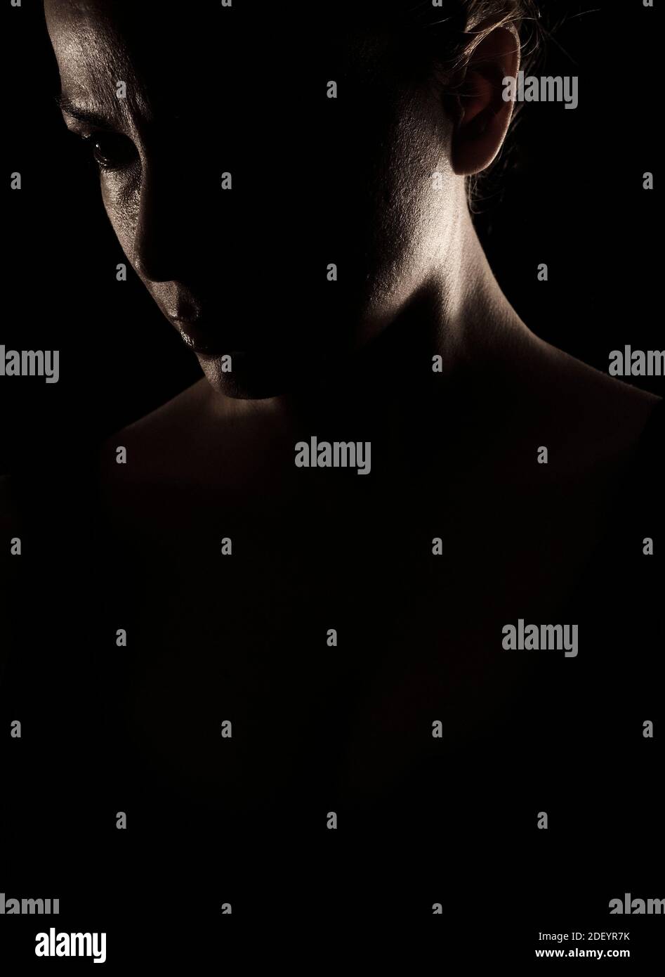 portrait of a woman with most of her face in shadow Stock Photo - Alamy