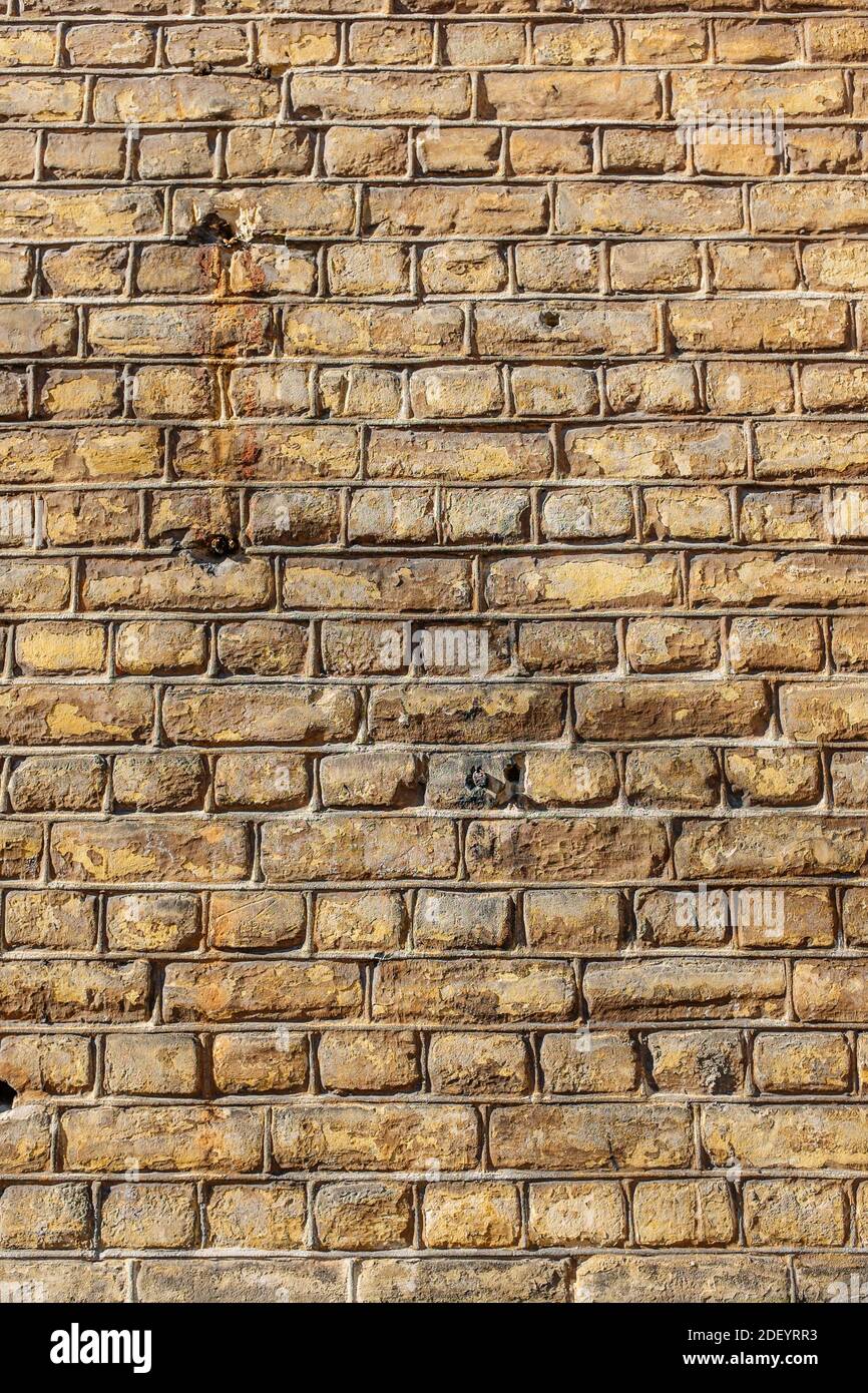 A vertical shot of a weathered brick wall - great for background or ...