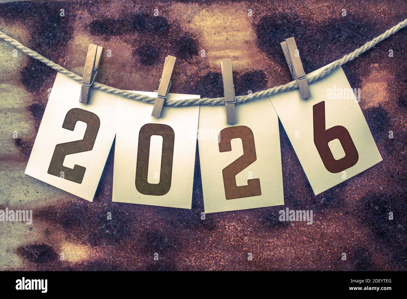 The year 2026 written on pinned cards against an old rusty background ...