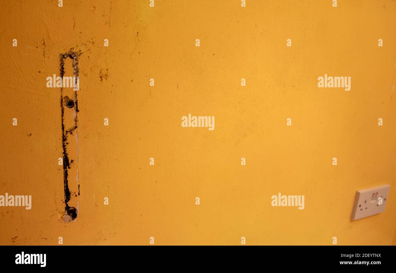 Yellow ochre kitchen wall with electric sockets during a kitchen ...