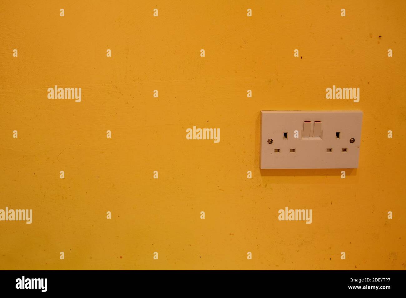 Yellow ochre kitchen wall with electric sockets during a kitchen ...