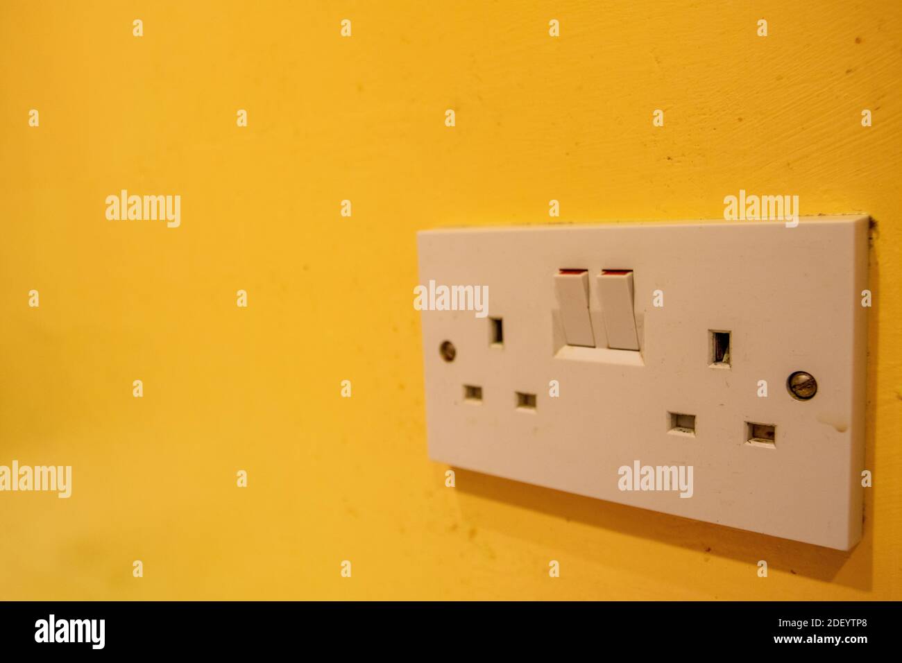 Yellow ochre kitchen wall with electric sockets during a kitchen ...
