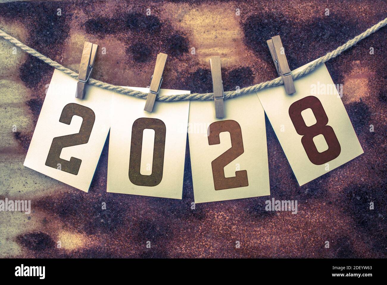The year 2028 written on pinned cards against an old rusty background ...