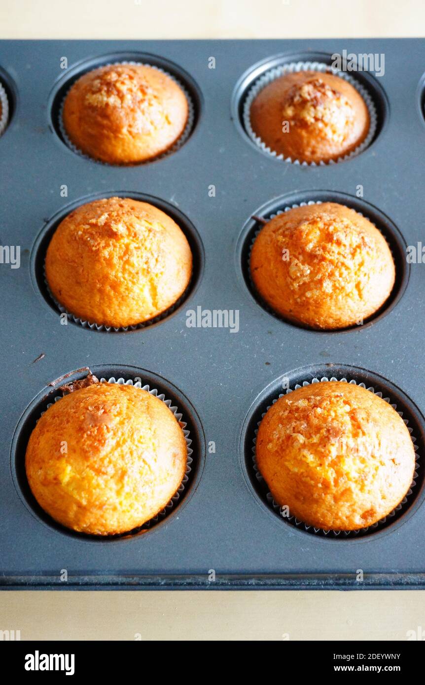 A vertical closeup of fresh muffins in a muffin pan Stock Photo - Alamy