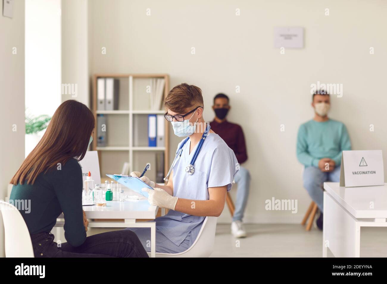 Patient filling in questionnaire before hi-res stock photography and ...