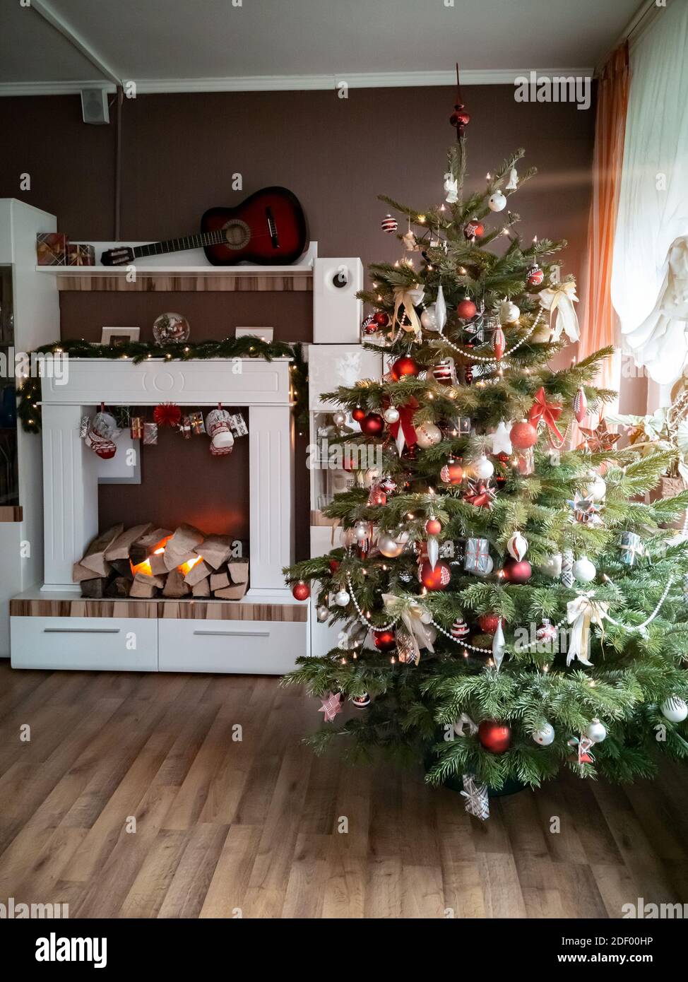 Christmas tree is in the living room. The sun shines out of the window ...