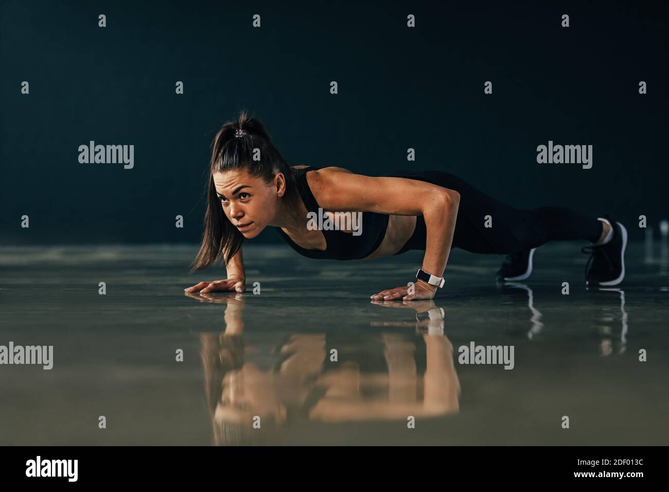 Strong woman doing push ups exercises indoors Stock Photo - Alamy