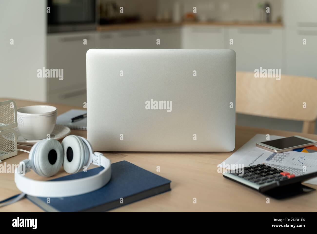 Freelance desk with laptop in kitchen room. Work from home. Distance ...