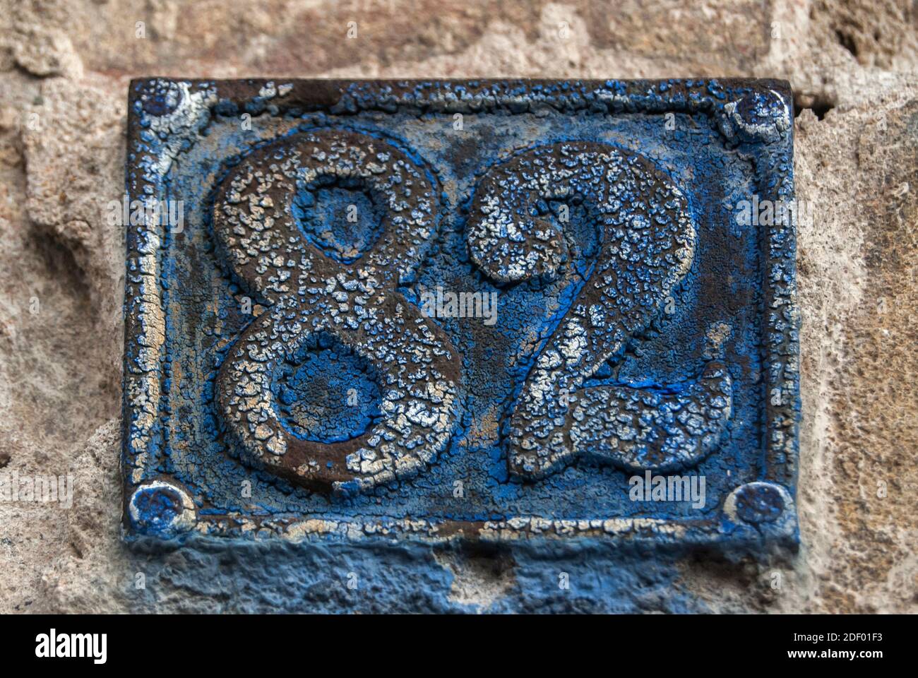 Old retro weathered cast iron plate with number 82 closeup Stock Photo ...