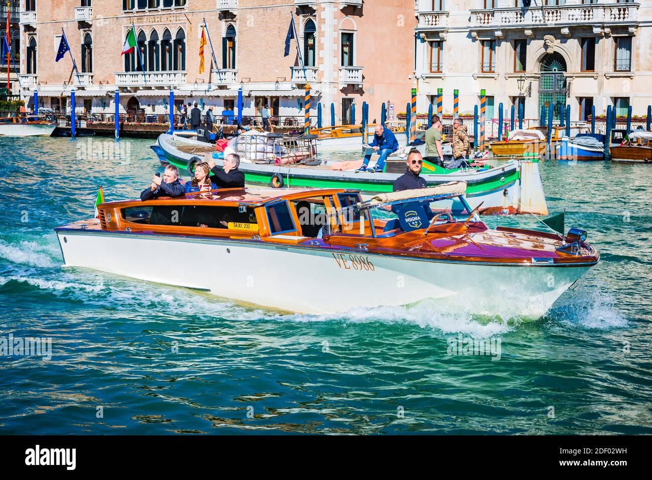 Water taxi with passengers on Grand canal. Venice, Veneto, Italy ...