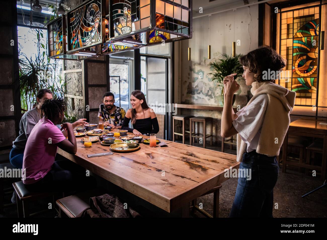 A young girl playing a word-guessing game with her friends, she has to ...