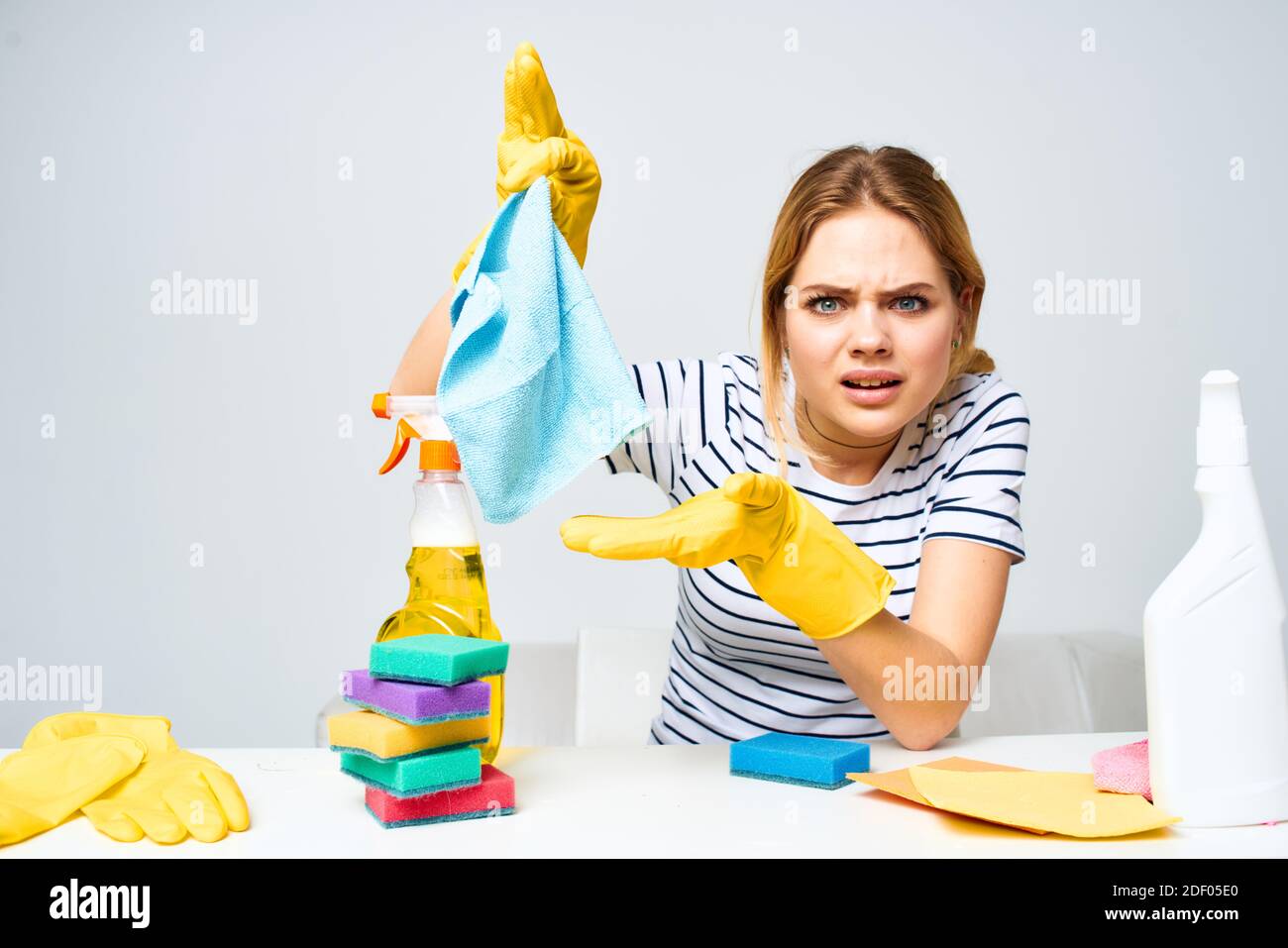 A cleaning lady sits at a table providing housekeeping services light ...