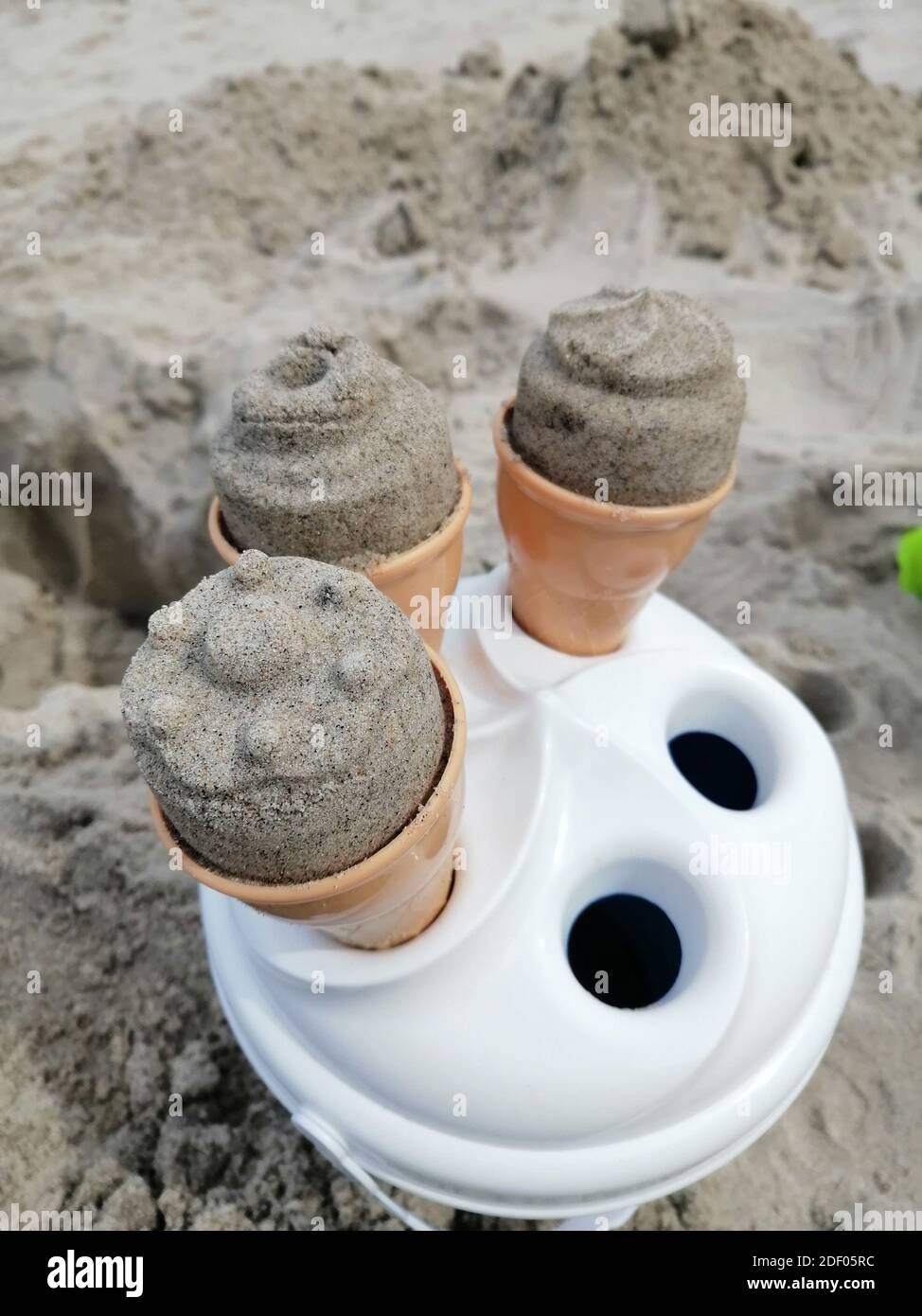 A vertical shot of ice cream cones made with beach sand Stock Photo - Alamy