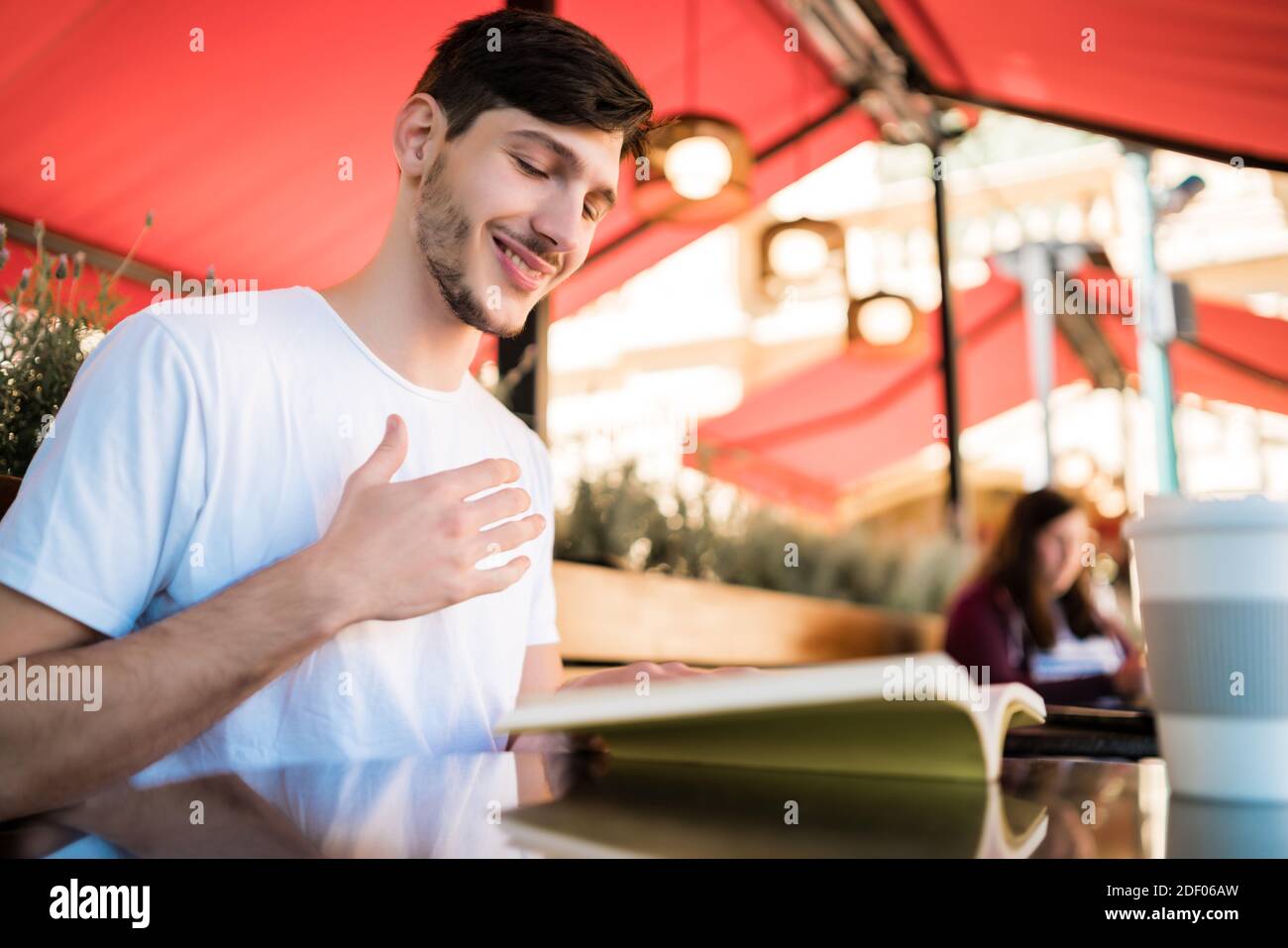 Concentrated man enjoying book sitting hi-res stock photography and ...