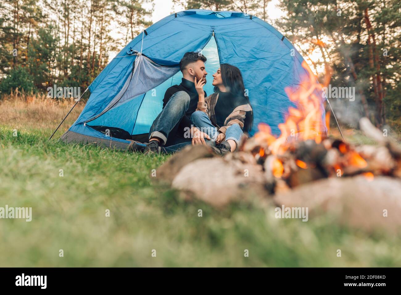 Romantic couple sitting in tent Stock Photo - Alamy