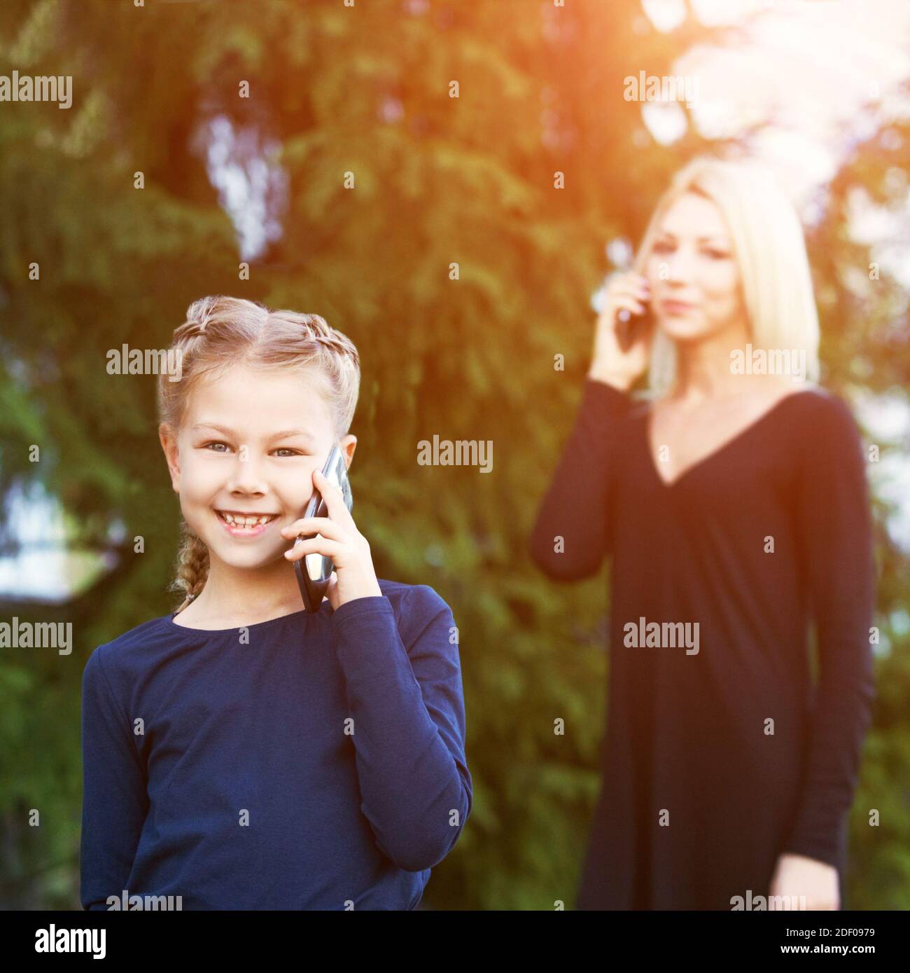 Mom and daughter. Phone conversation. Happy family portrait Stock Photo ...