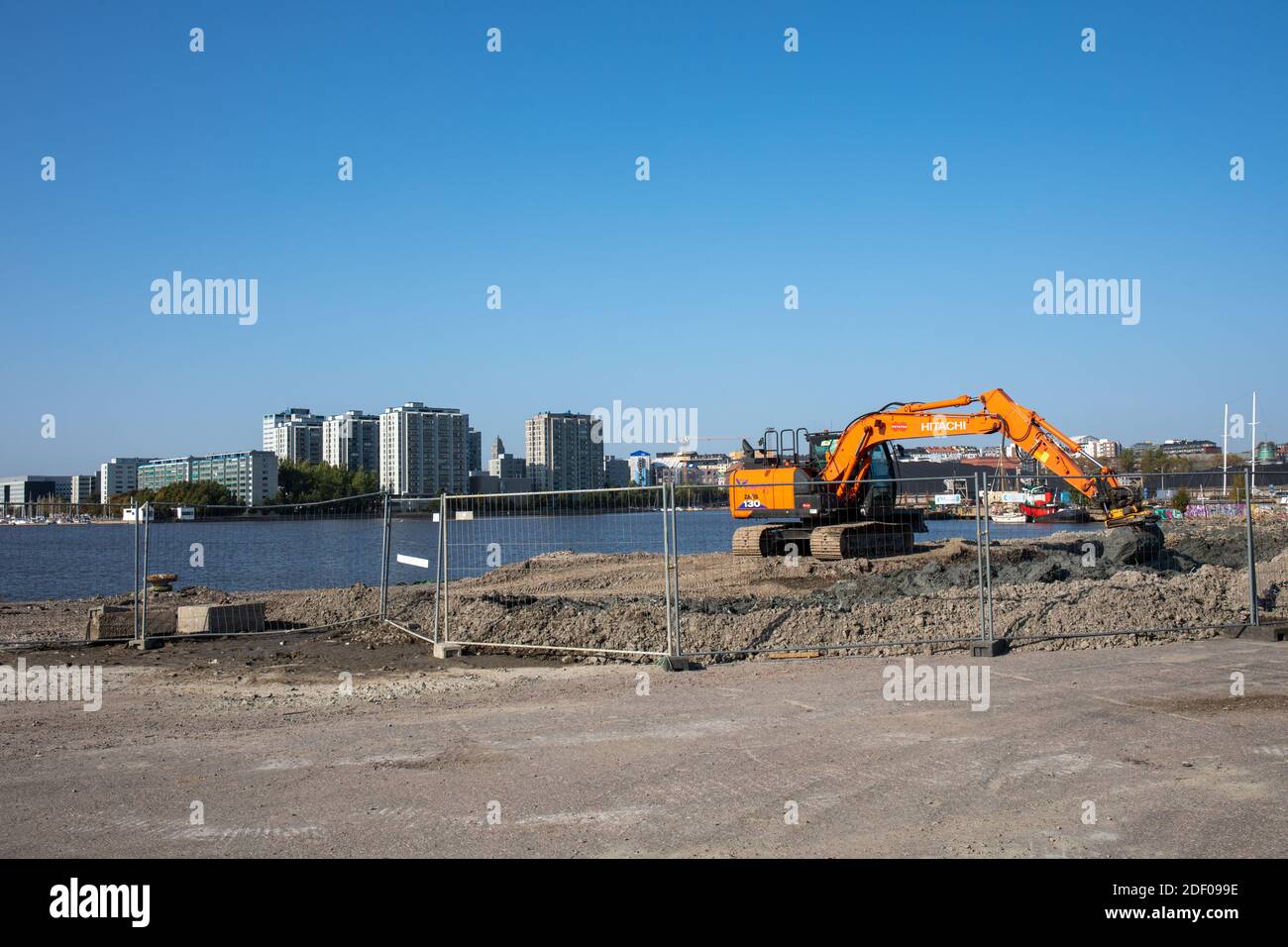 Excavator in Sompasaari with Merihaka district in background in ...