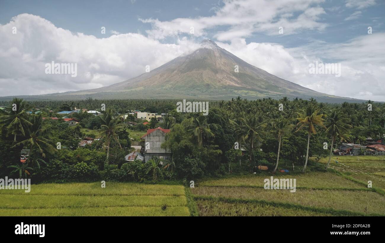 Tropic rural city at palm trees aerial. Mayon volcano countryside with ...