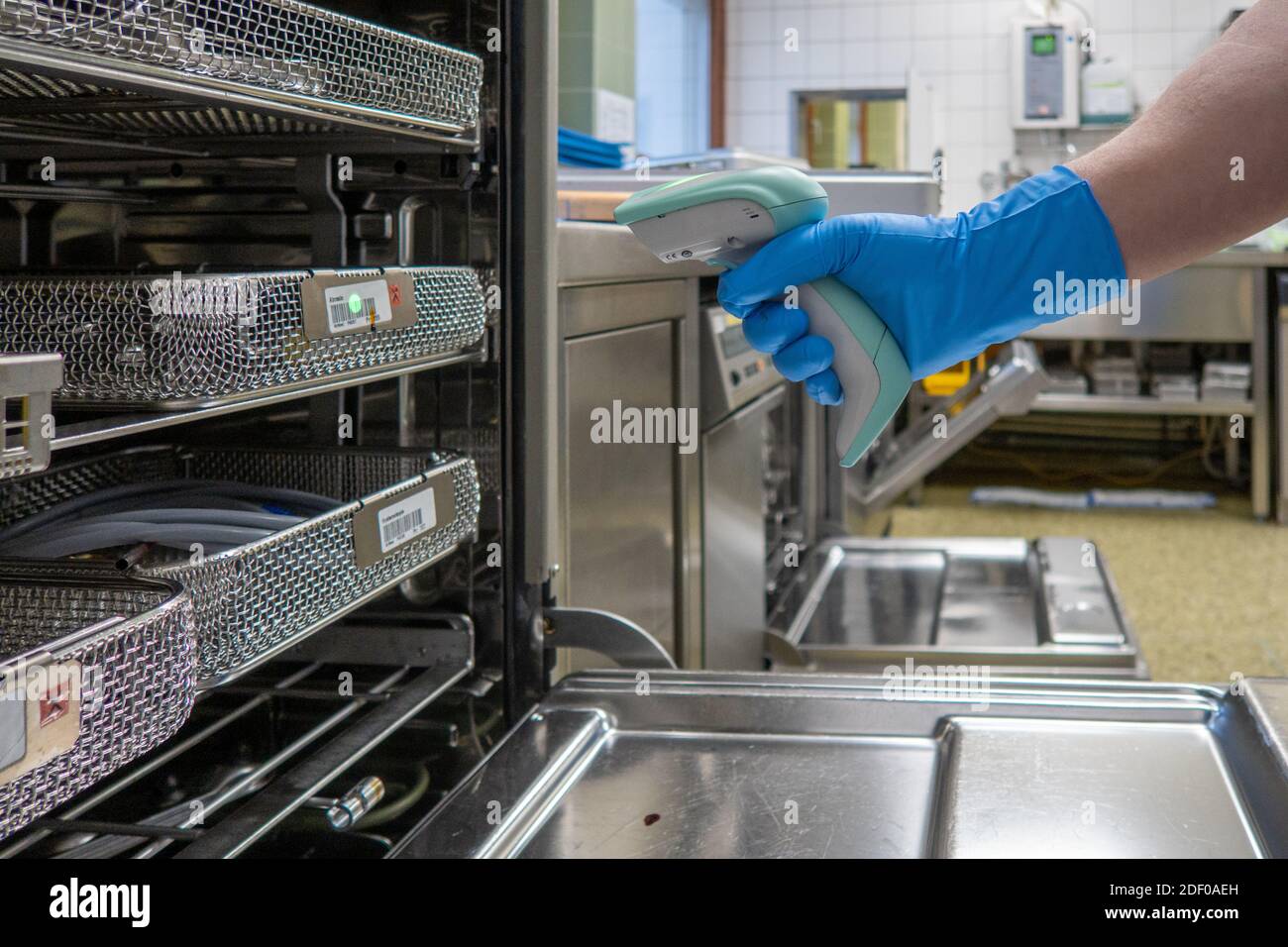 hospital employee scans instrument trays with a barcode scanner Stock ...