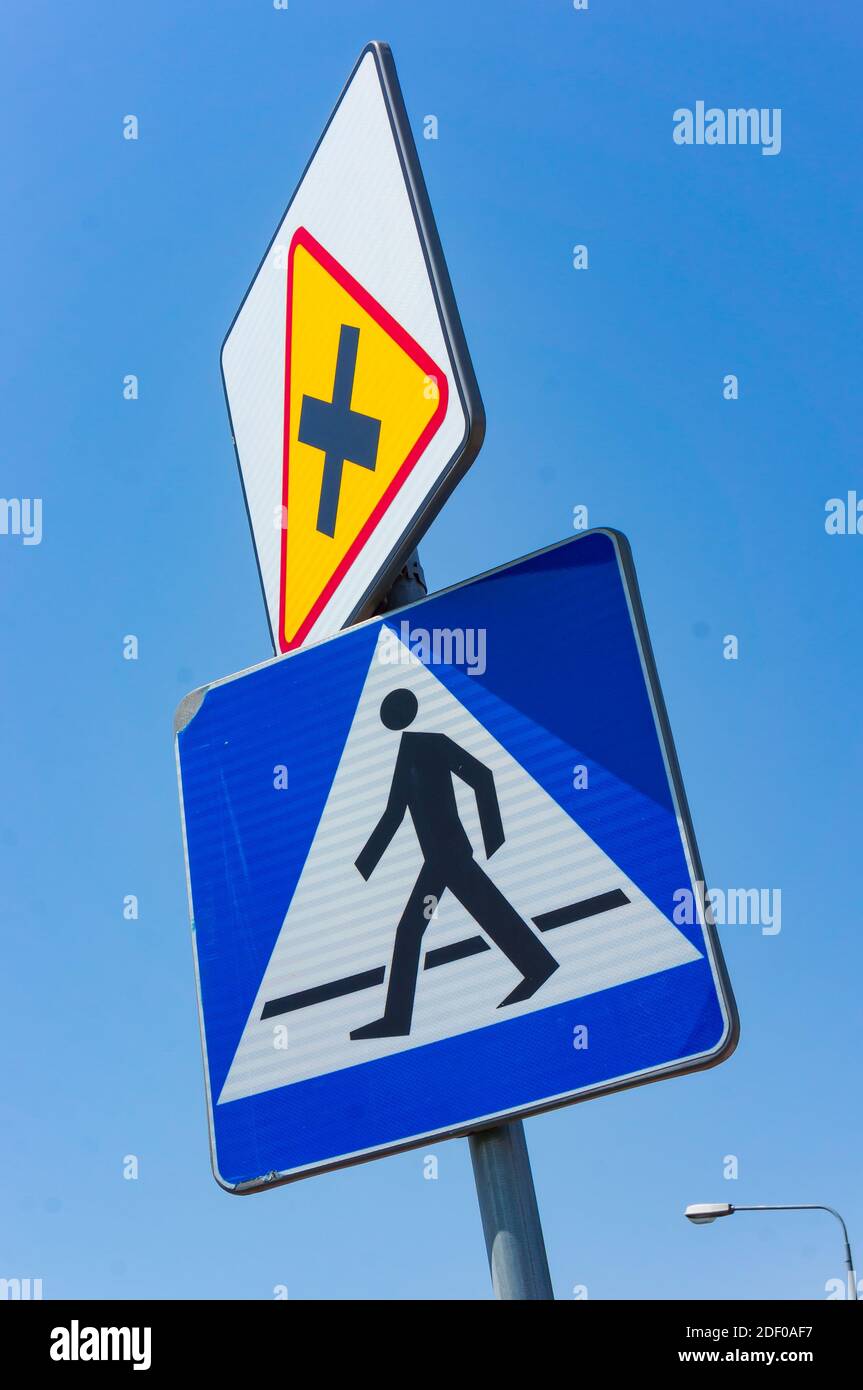 A vertical low angle shot of pedestrian traffic signs Stock Photo - Alamy