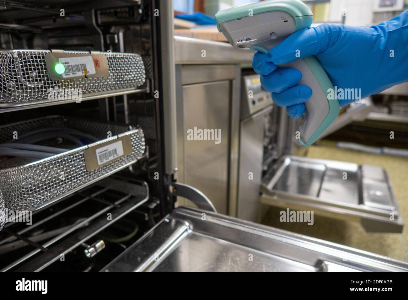 hospital employee scans instrument trays with a barcode scanner Stock ...