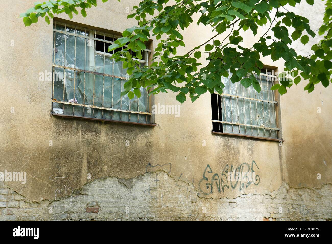 A facade of an old building with worn out wall and broken window Stock ...