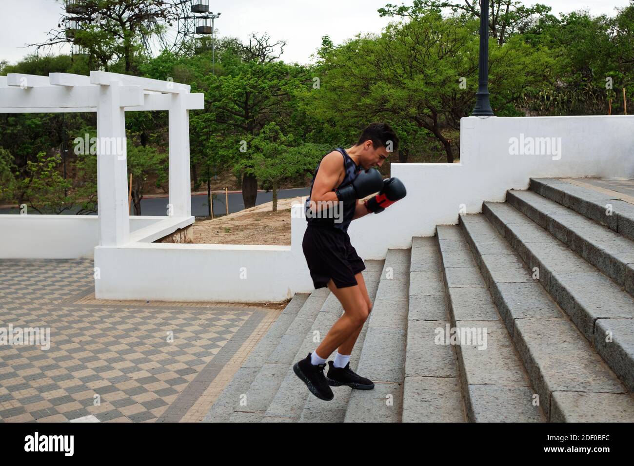 White caucasian boxer with black boxing gloves running on stairs Stock ...