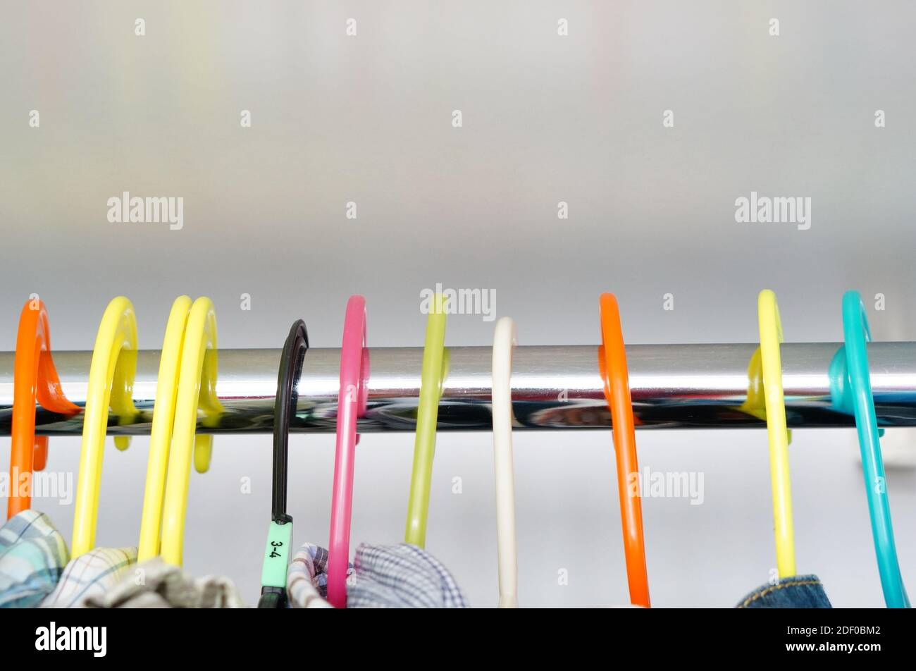 The colorful plastic hangers of the wardrobe with a white background ...
