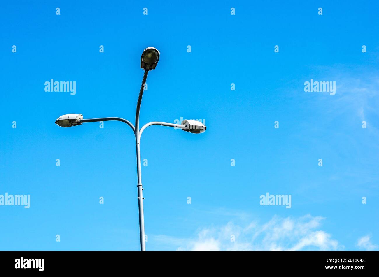 A low angle shot of a street light with a clear blue sky in the ...