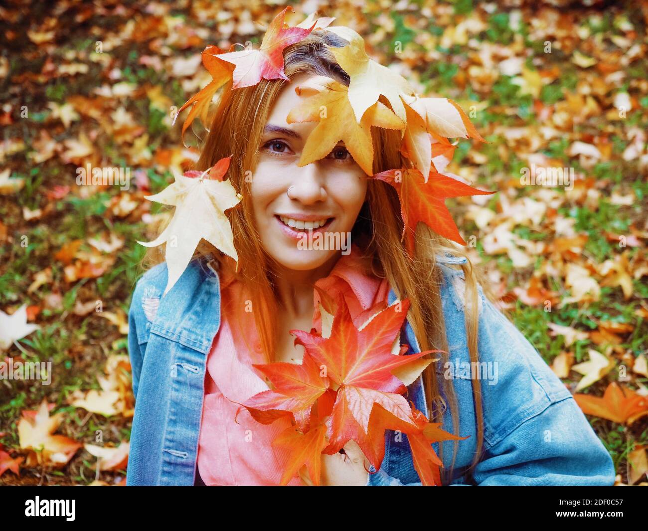 Autumn portrait of a girl with a head decorated with autumn leaves ...